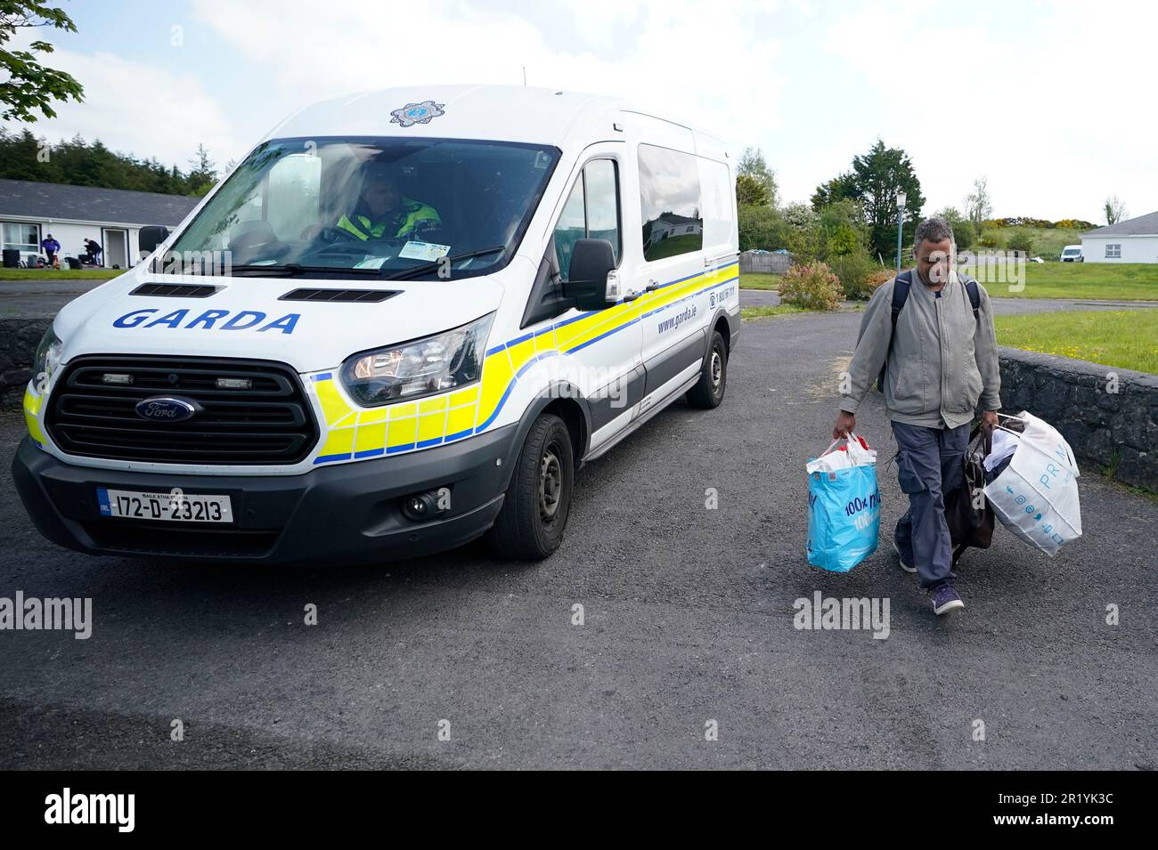 A man carries his belongings from the aylum seeker accommodation at the ...