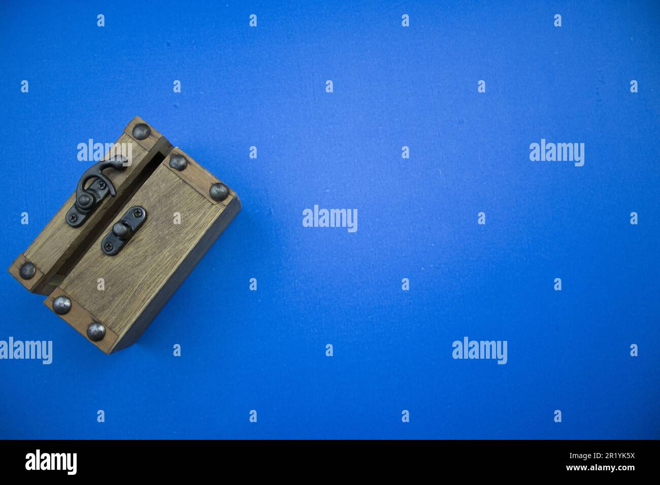 A wooden chest with a slightly open mouth, placed on the edge of the ...