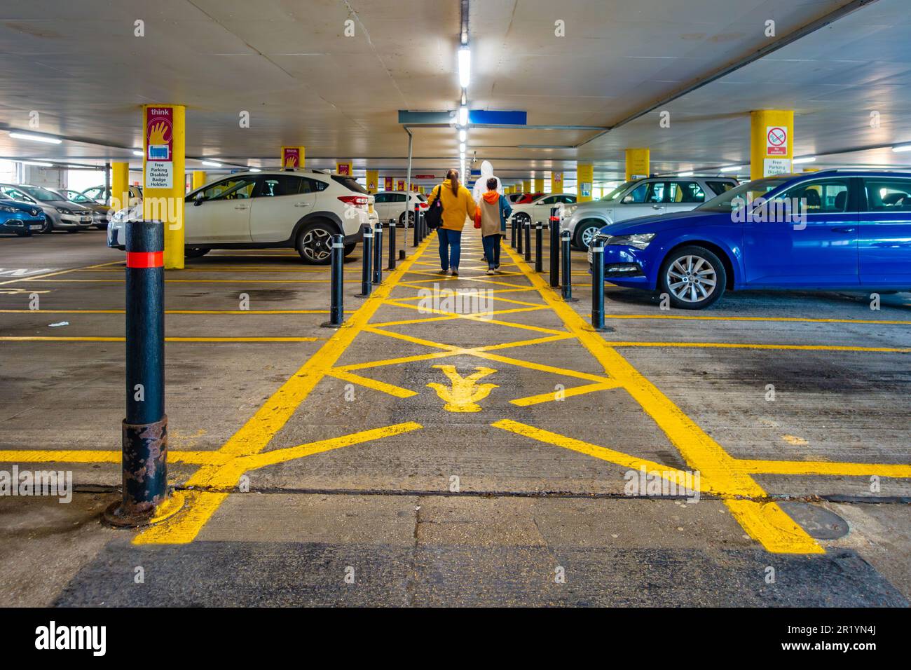 A mother and sons walk back to their car through a multi-storey car ...