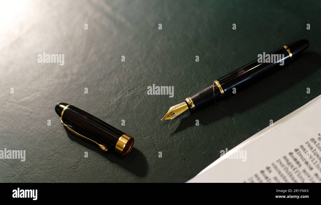 Open fountain pen on desk with typed paper, a contrast of past and ...