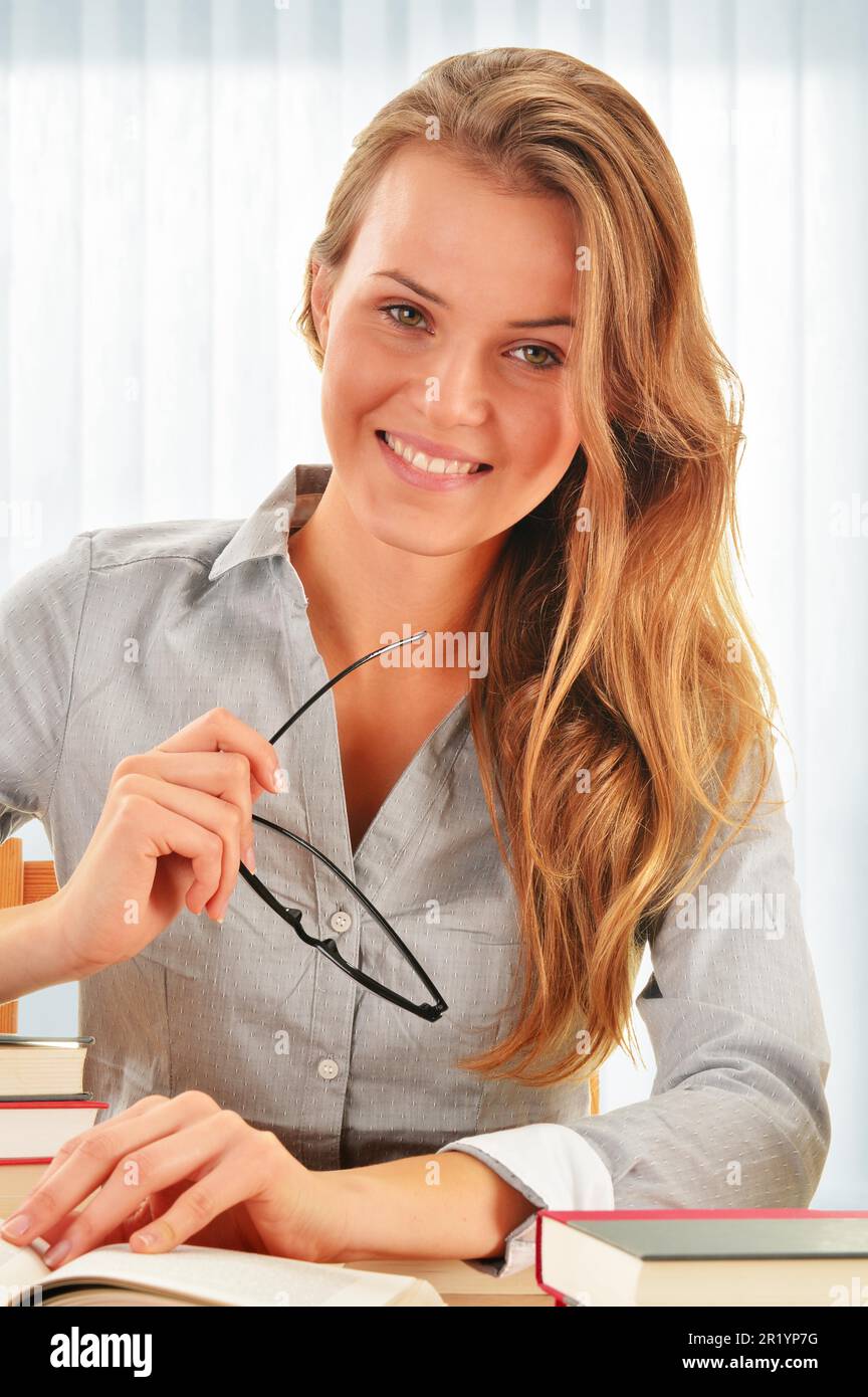 Female student learning in the library Stock Photo - Alamy