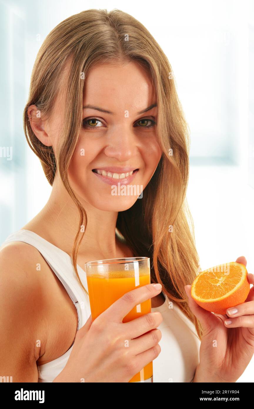 young woman holding glass of orange juice Stock Photo - Alamy
