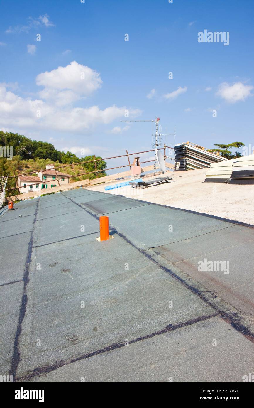 Italian construction site with roof covered with thermal insulation and ...