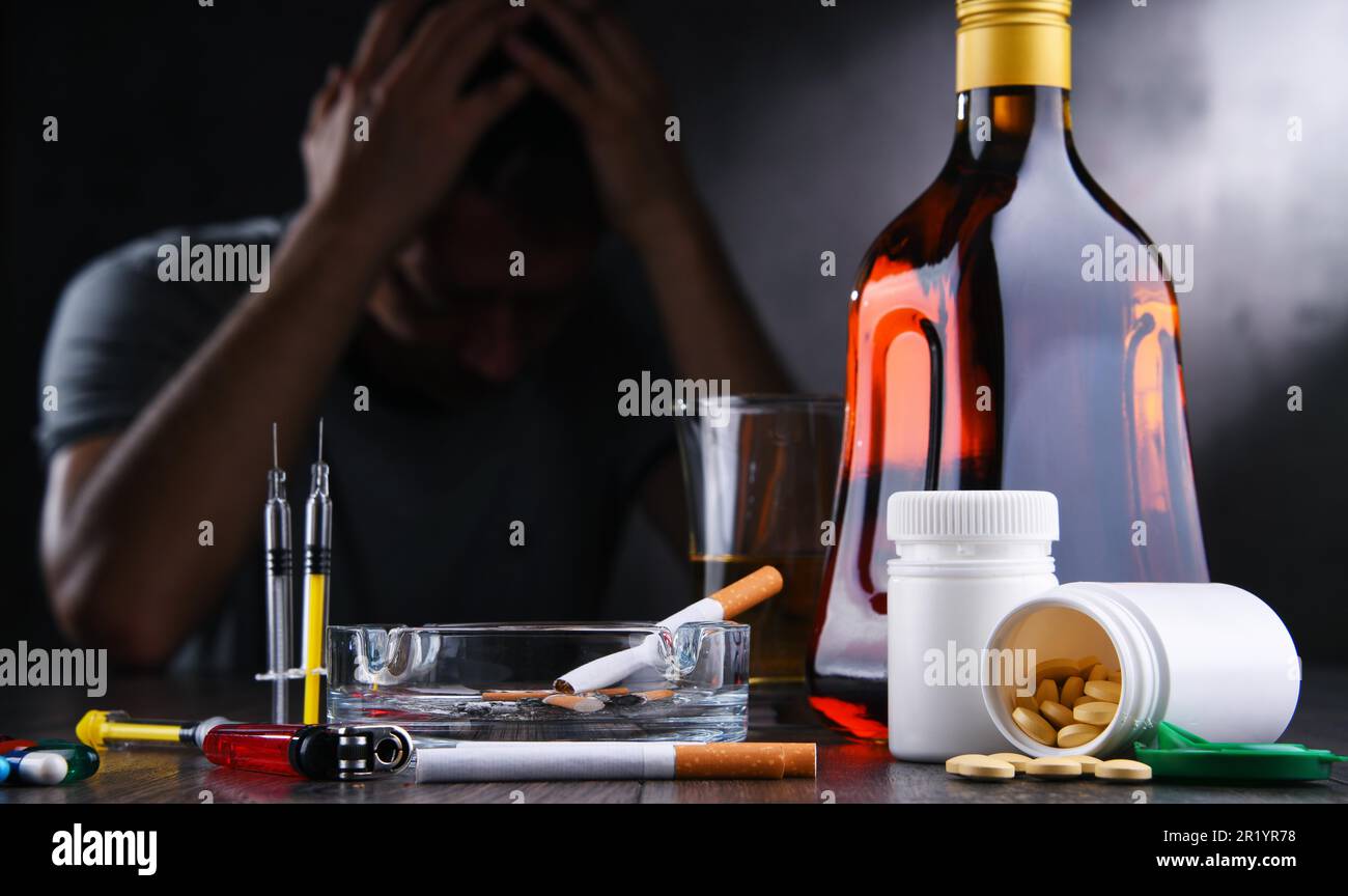 Addictive substances and the figure of a addicted man Stock Photo - Alamy