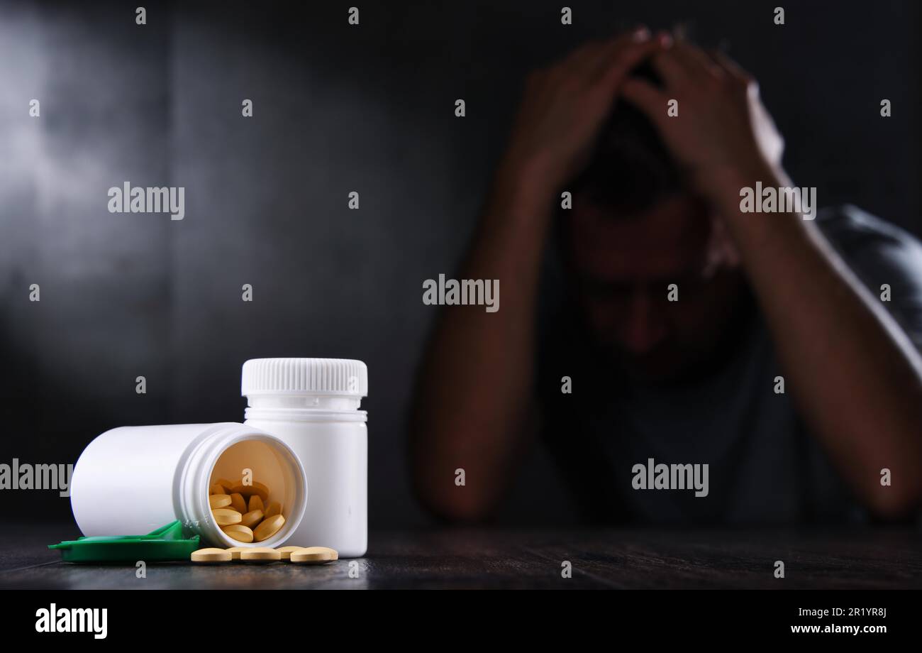 Drugs and the figure of a addicted man Stock Photo - Alamy