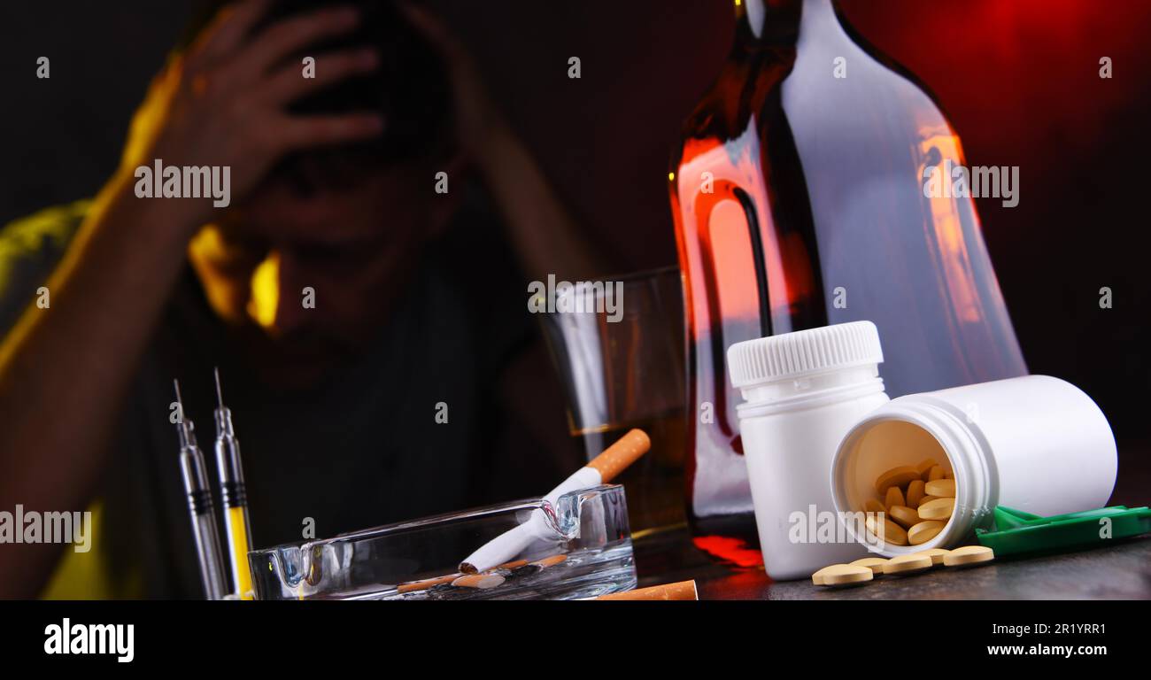 Addictive substances and the figure of a addicted man Stock Photo - Alamy