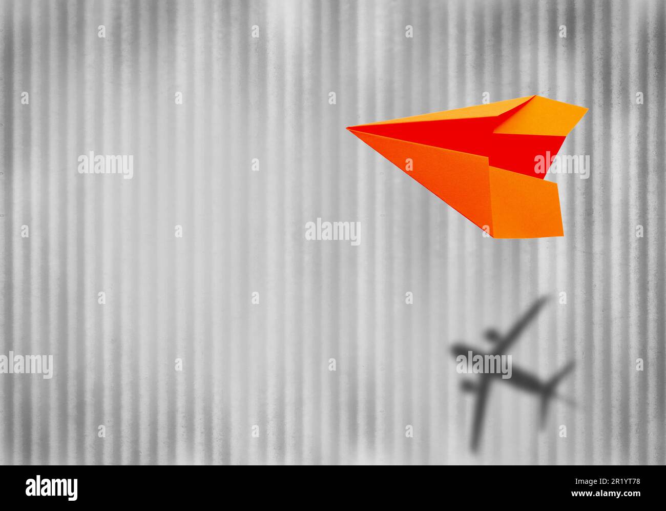 Flying paper plane and shadow of a real airplane on light textured ...