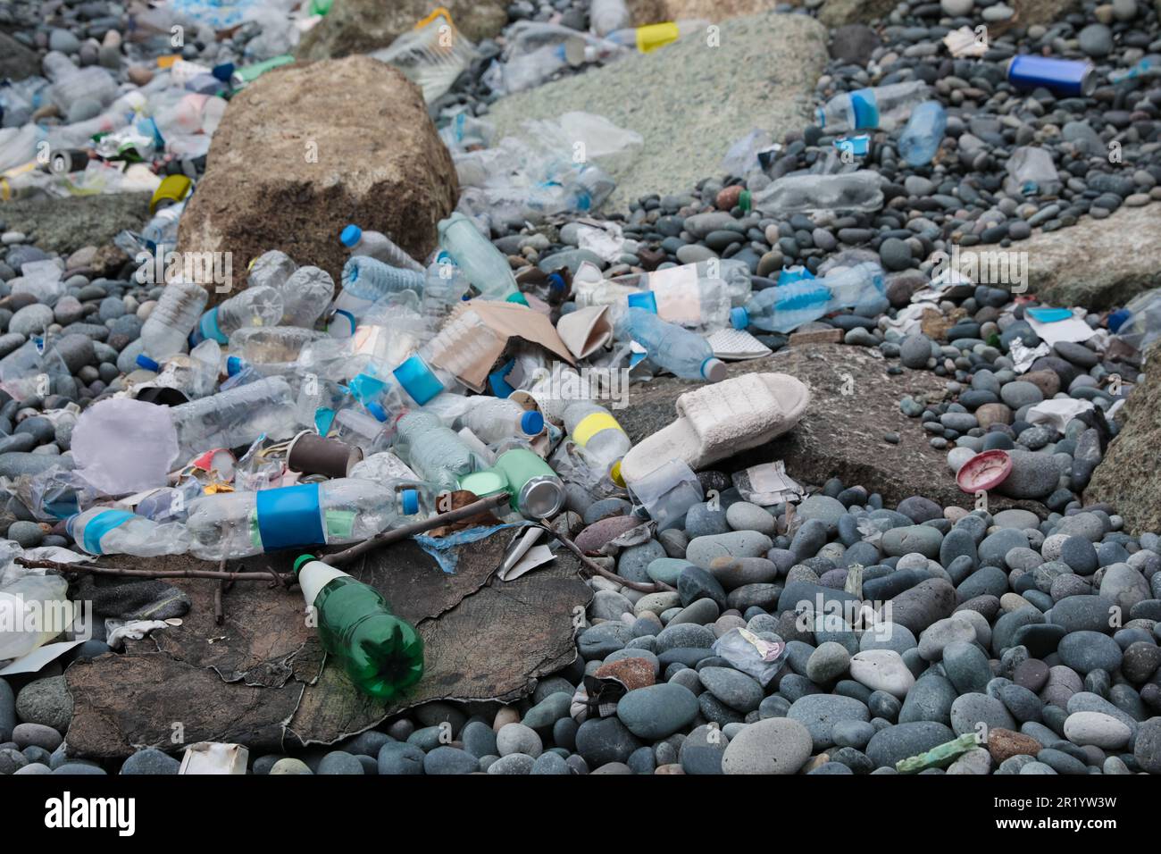 Garbage scattered on pebbles outdoors. Recycling problem Stock Photo ...