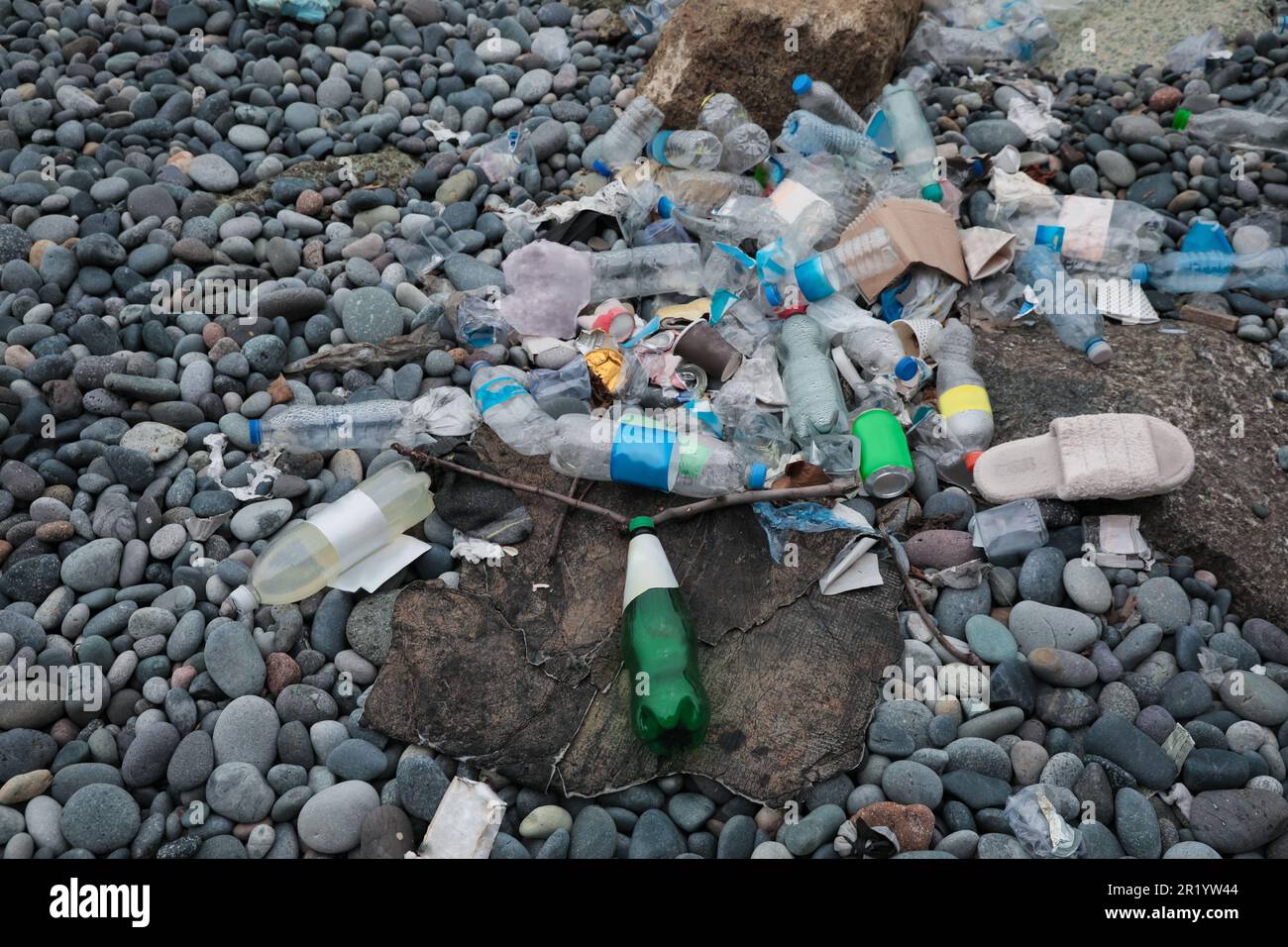 Garbage scattered on pebbles outdoors. Recycling problem Stock Photo ...
