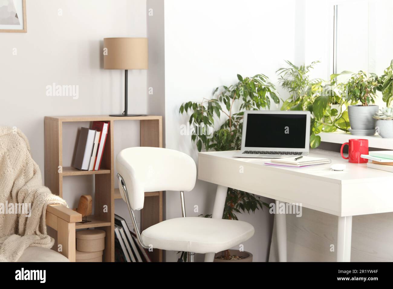 Stylish workplace with laptop on white desk near window Stock Photo - Alamy