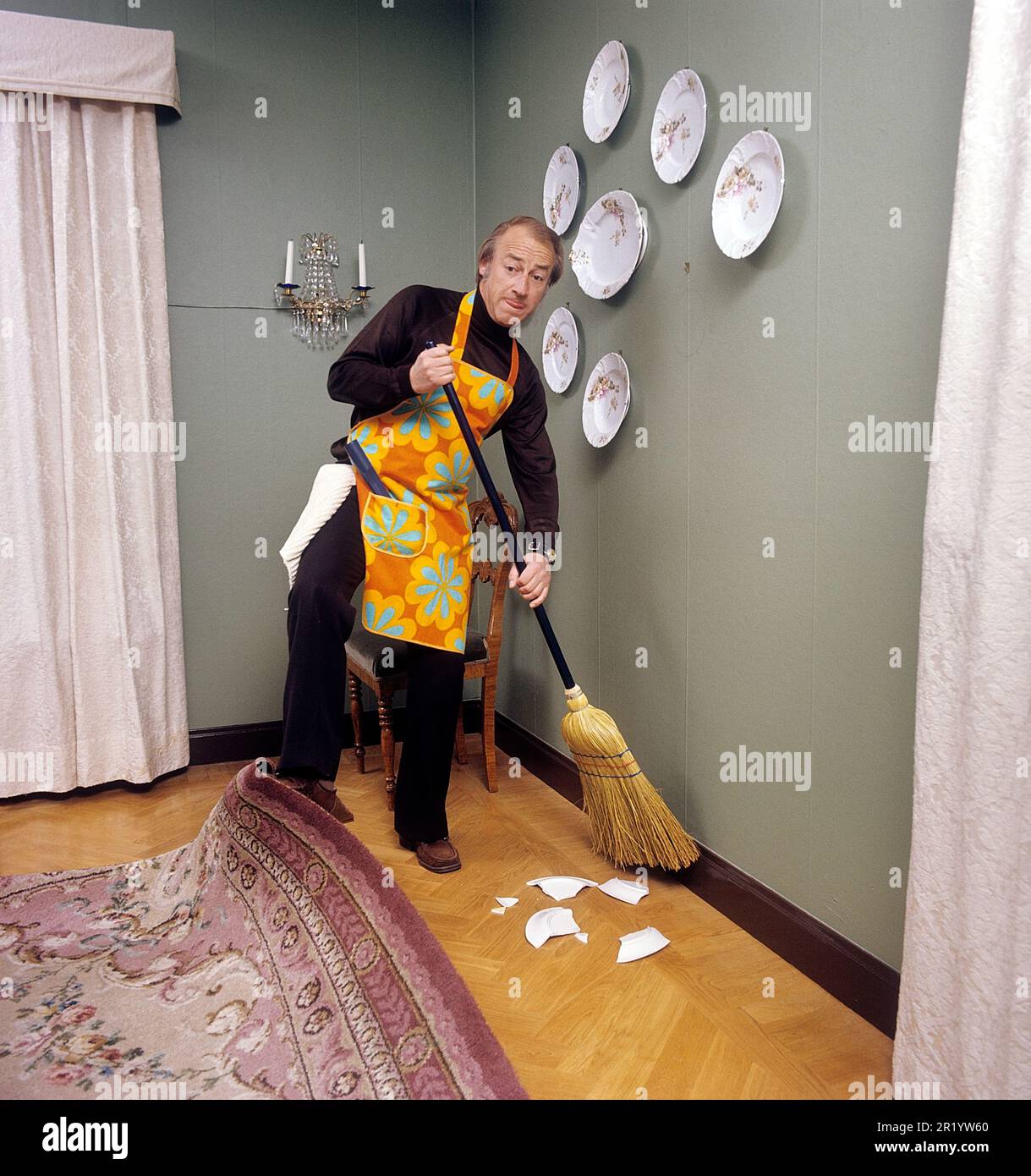 Cleaning day in the 1970s. An interior of a man cleaning the floor ...