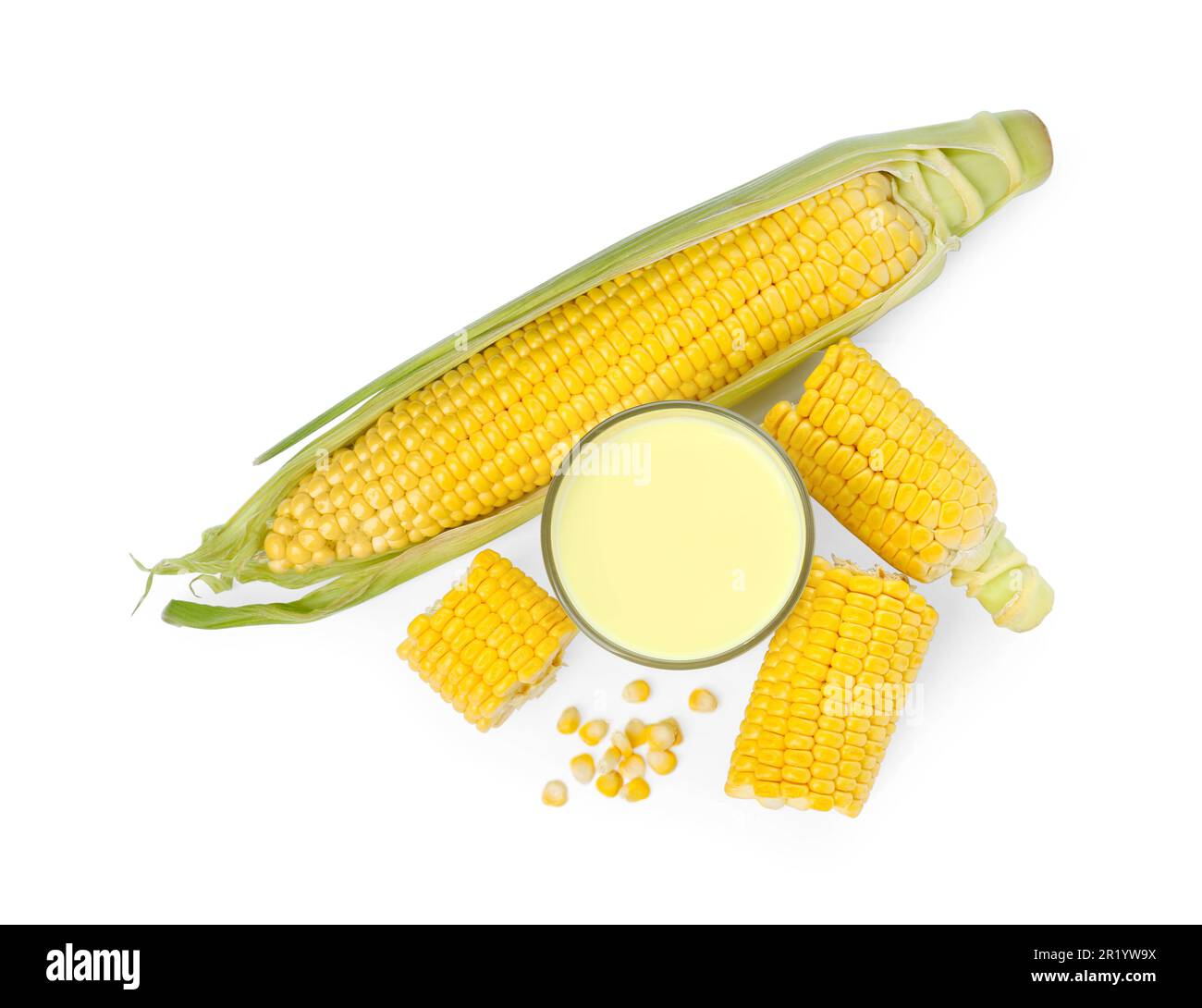 Tasty fresh corn milk in glass and cobs on white background, top view ...