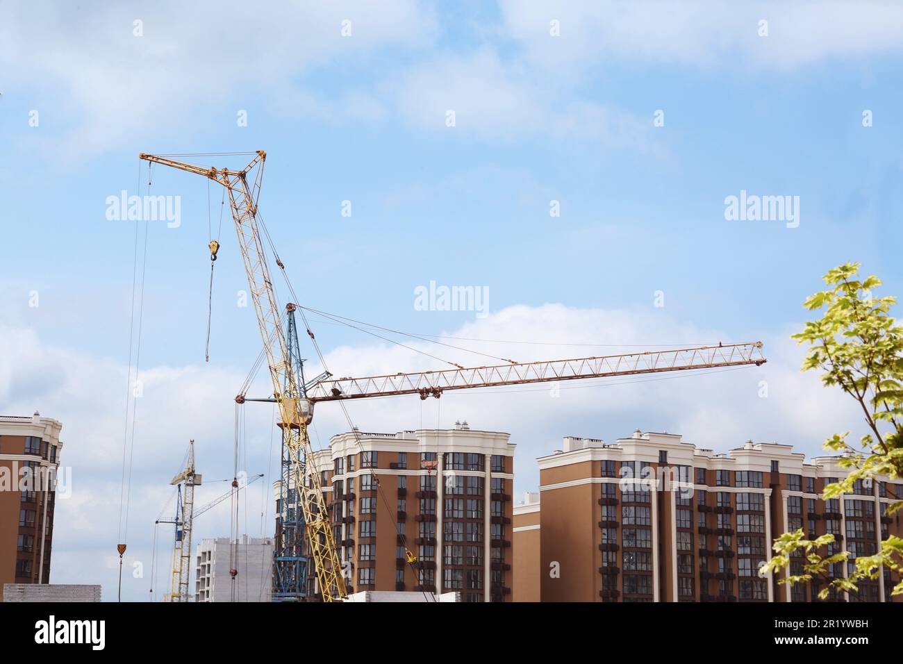 Construction site with tower crane near building Stock Photo - Alamy