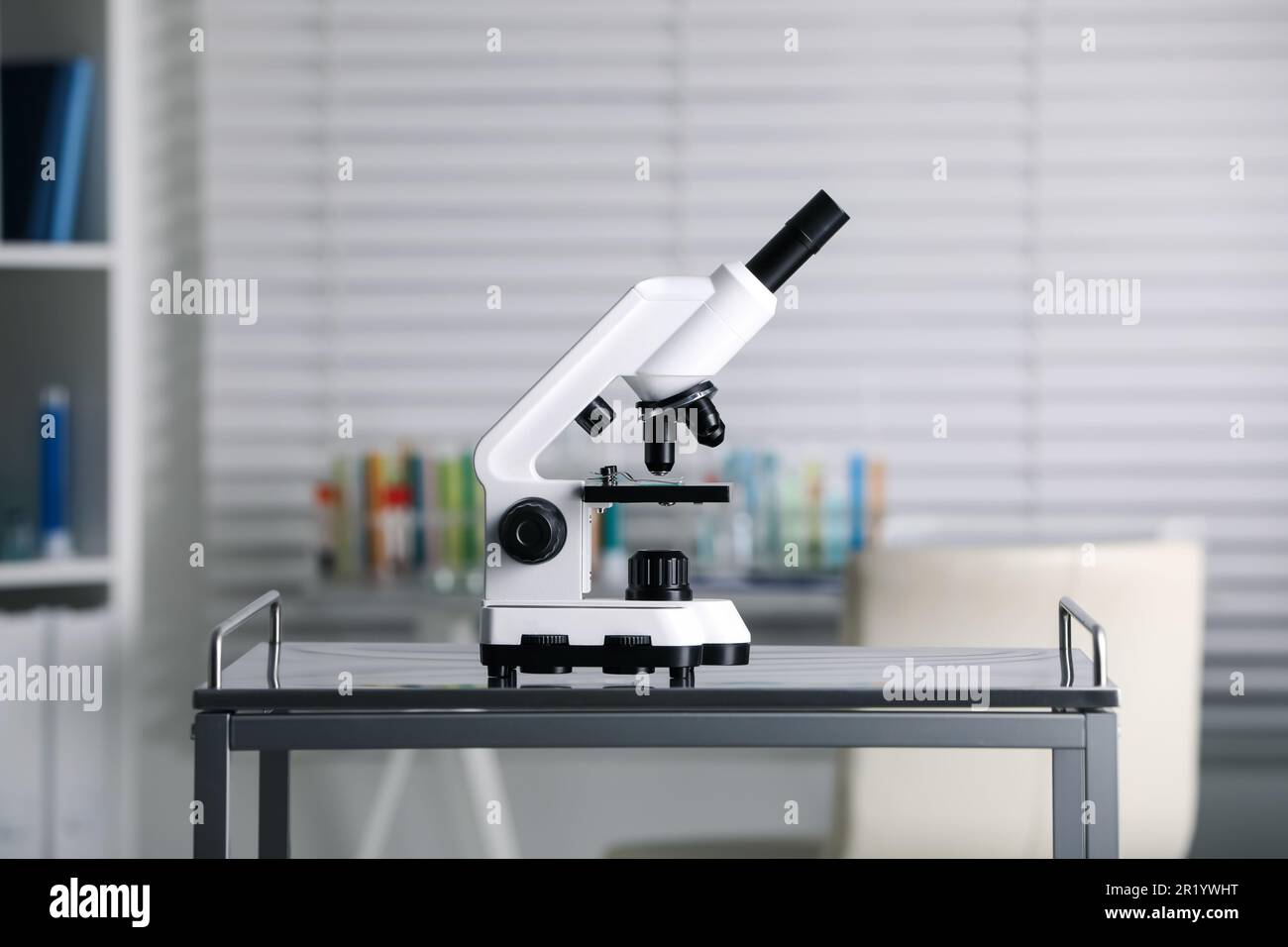 Modern medical microscope on metal table in laboratory Stock Photo - Alamy