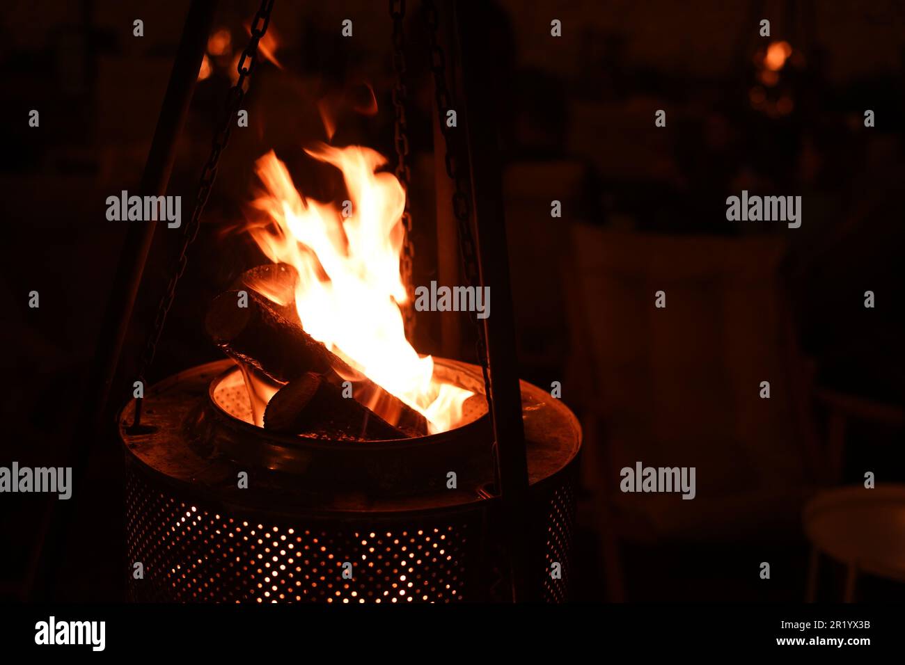 A roaring campfire burning in an open flame pit, with a plethora of ...