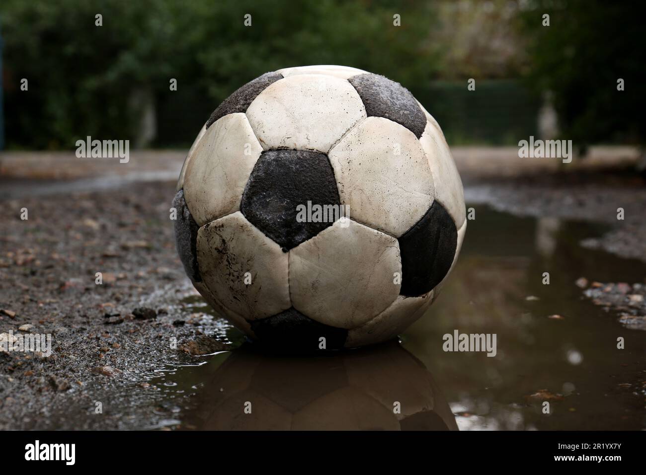 Dirty soccer ball in muddy puddle outdoors Stock Photo - Alamy