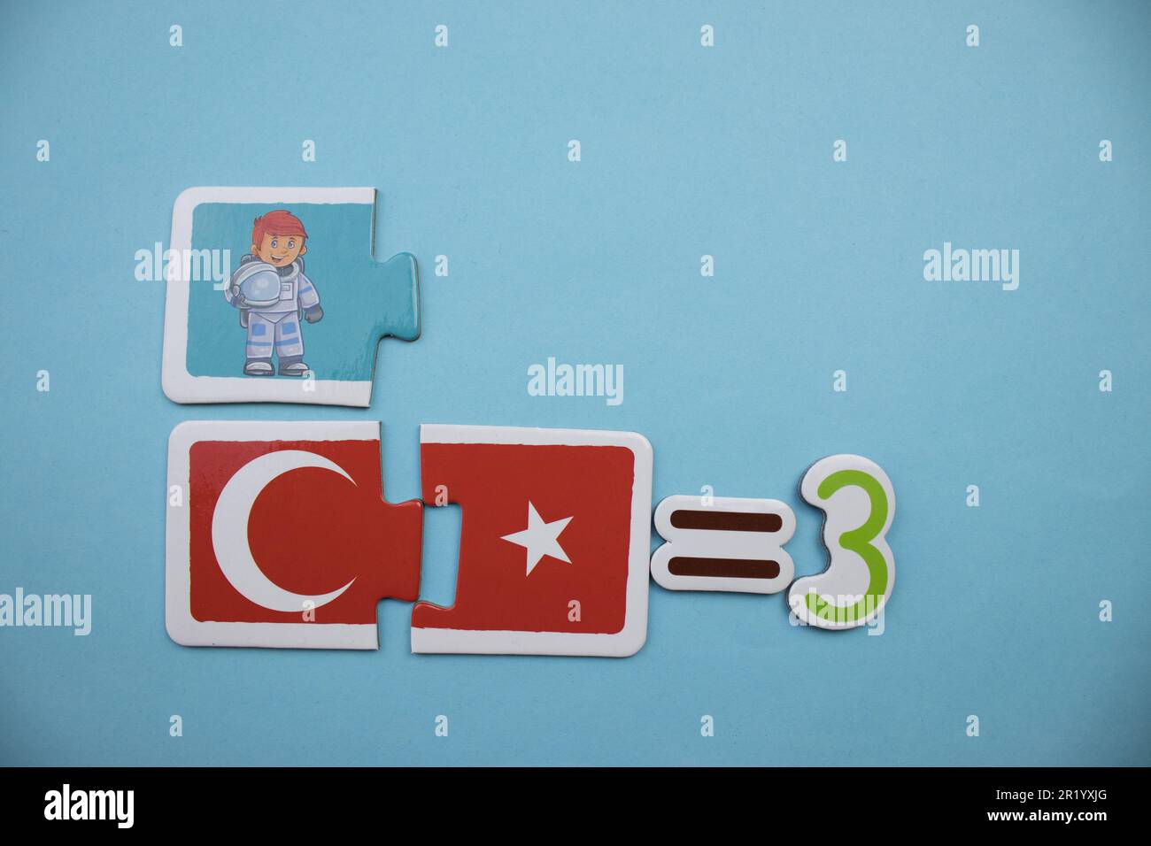 Mathematical operation with educational puzzles placed on a blue ...