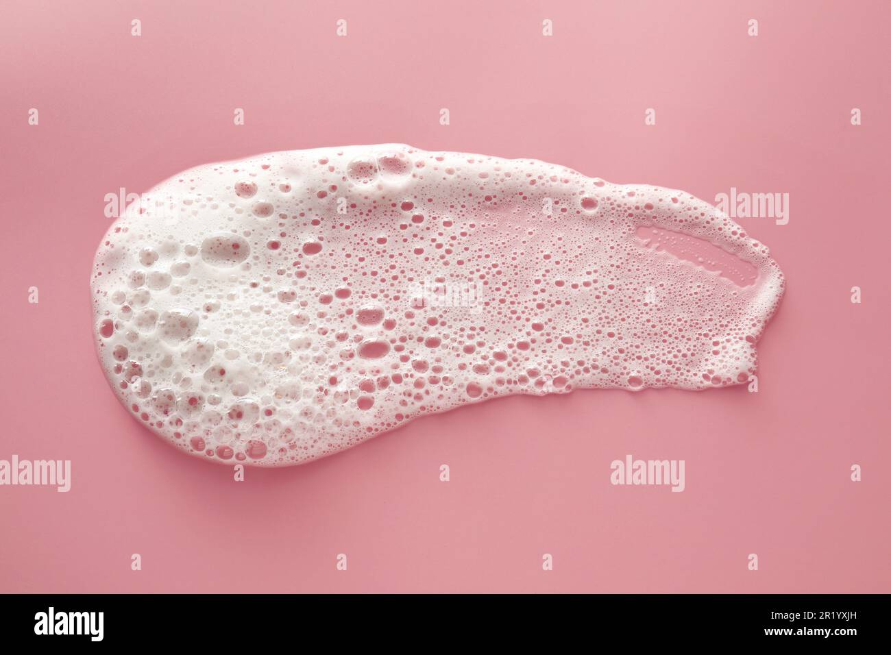 Smudge of white washing foam on pale pink background, top view Stock ...