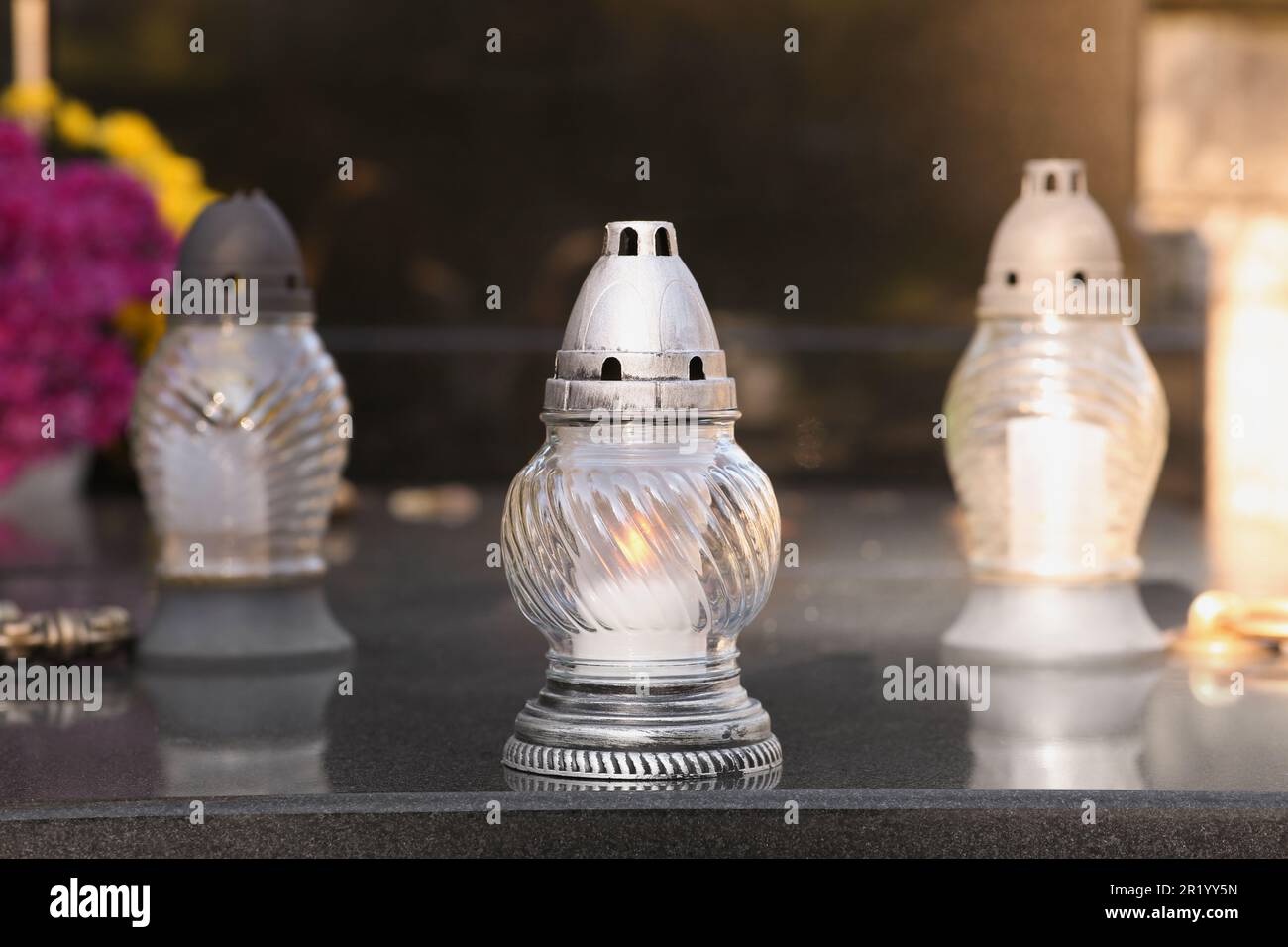 Grave lanterns on granite surface in cemetery Stock Photo - Alamy