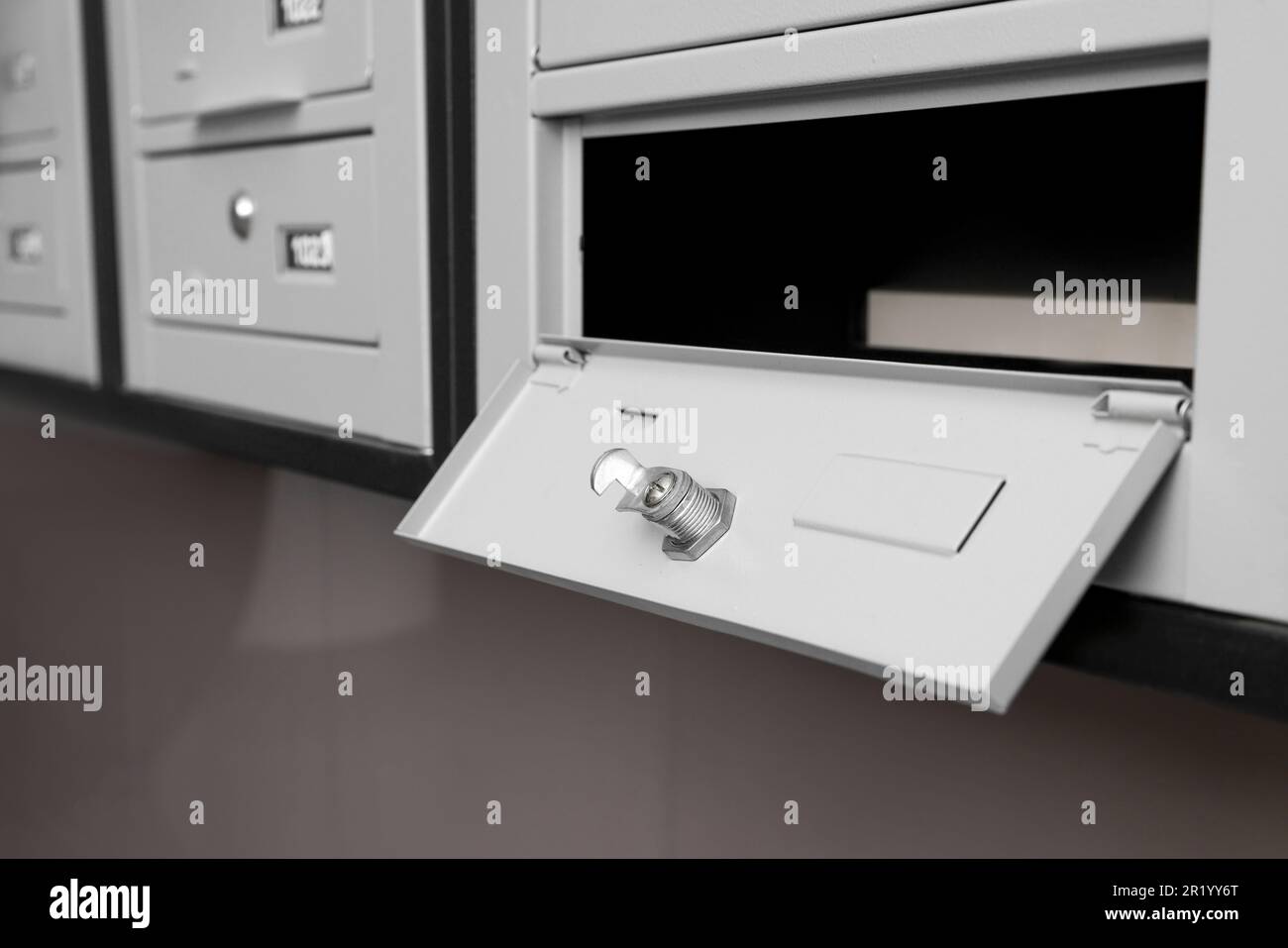 Open empty metal mailbox with keyhole indoors Stock Photo - Alamy