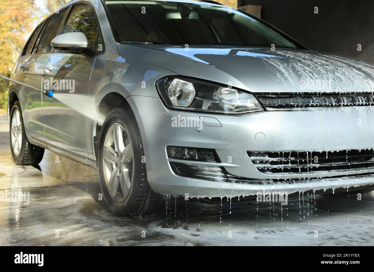 Washing auto with high pressure water jet at outdoor car wash Stock ...