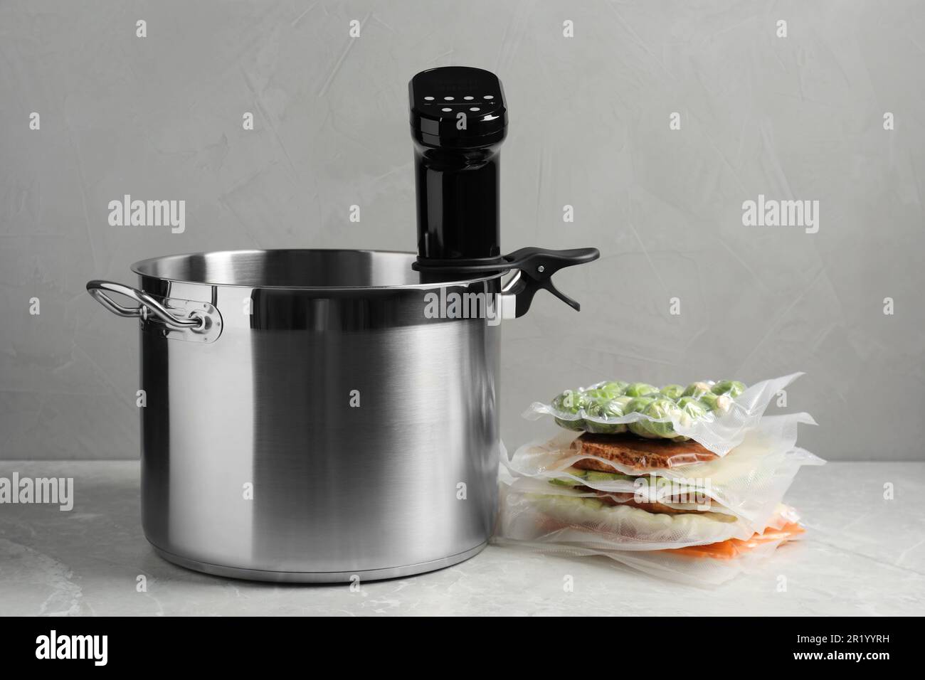 Sous vide cooking. Thermal immersion circulator in pot and vacuum ...