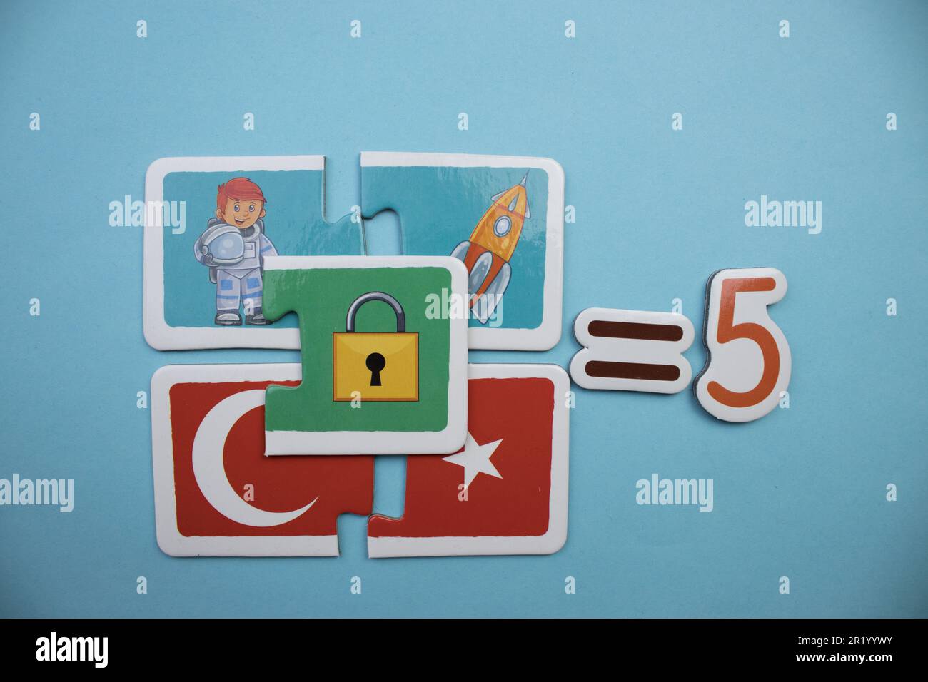 Mathematical operation with educational puzzles placed on a blue ...