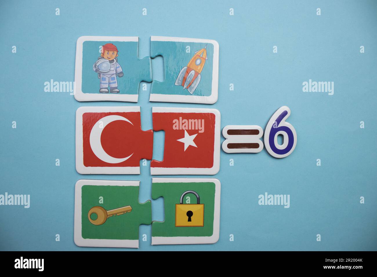 Mathematical operation with educational puzzles placed on a blue ...