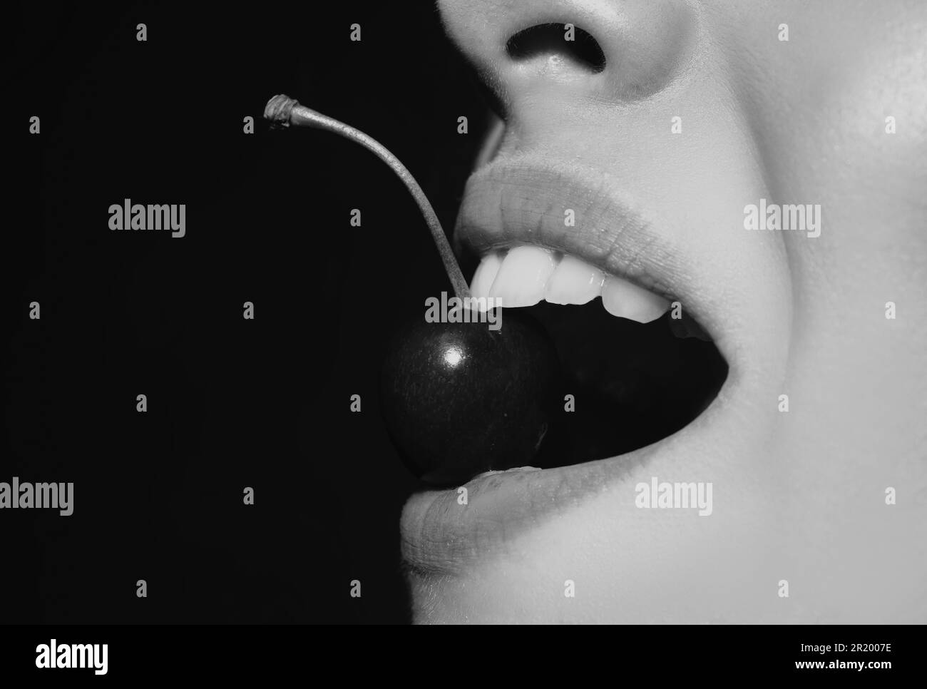 Cherry in teeth, macro, close up. Cherry in woman mouth. Cherries on ...