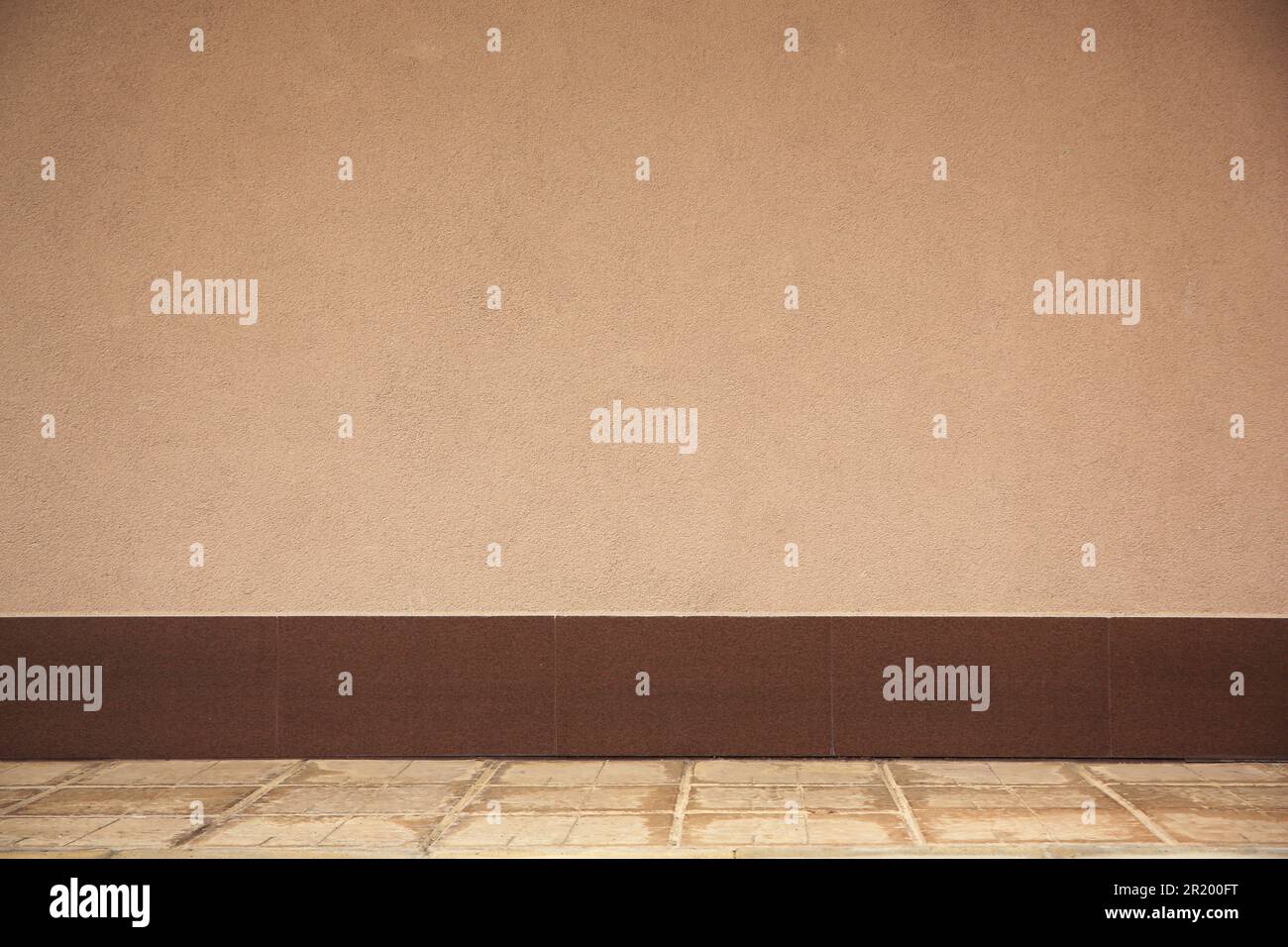 Beautiful plaster beige wall and concrete pavement Stock Photo - Alamy