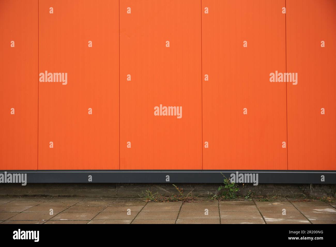 Beautiful orange wall and stone pavement outdoors Stock Photo - Alamy
