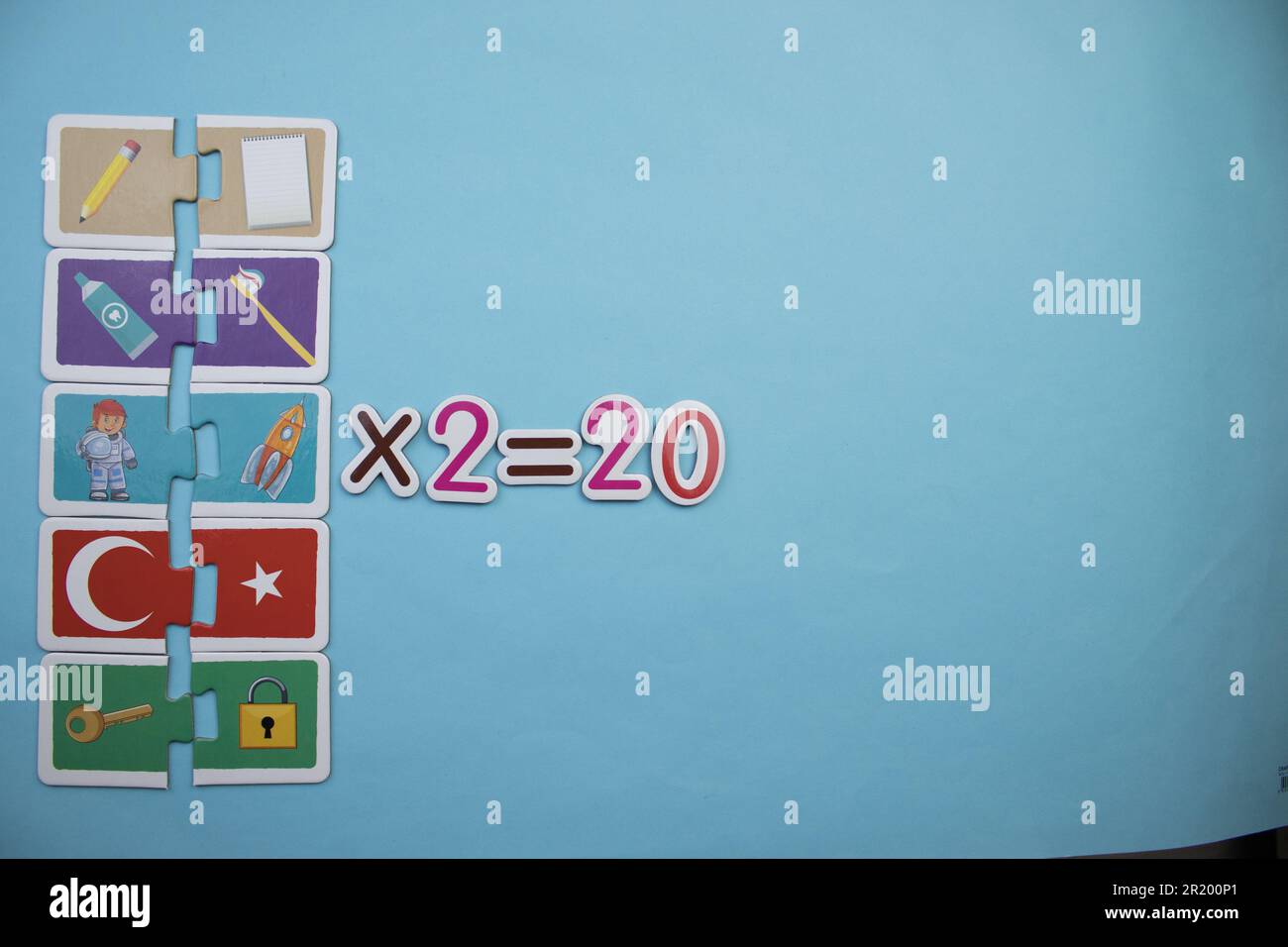 Mathematical operation with educational puzzles placed on a blue ...