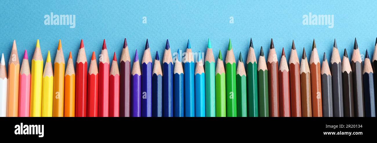 Flat lay composition with color pencils on blue background. Banner ...
