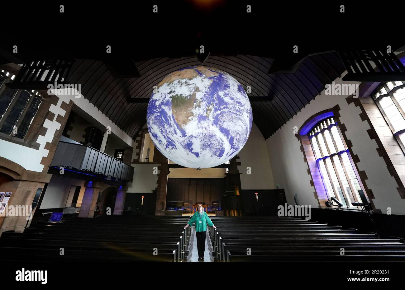 Volunteer Lillian Kerr views Gaia, Luke Jerram's seven-metre-wide ...