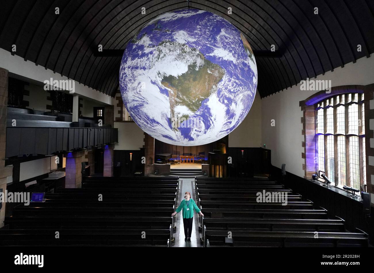Volunteer Lillian Kerr views Gaia, Luke Jerram's seven-metre-wide ...
