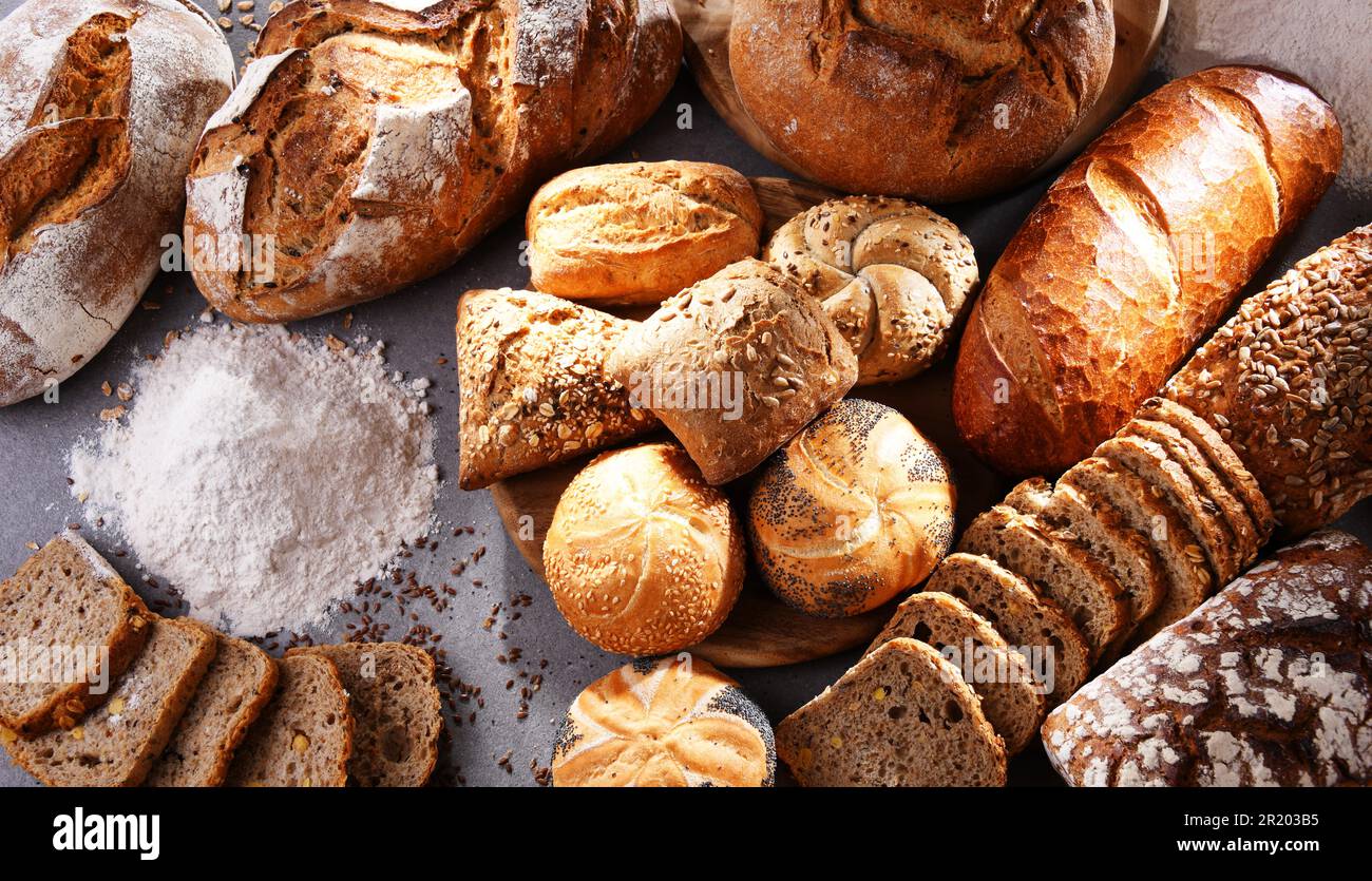 Assorted bakery products including loafs of bread and rolls Stock Photo ...