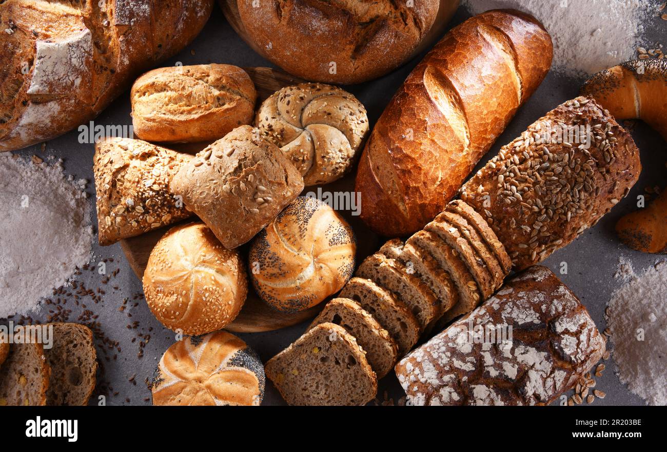 Assorted bakery products including loafs of bread and rolls Stock Photo ...