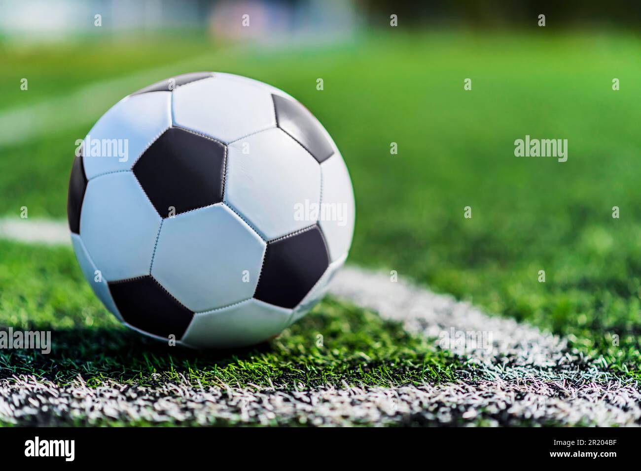 Leather soccer ball on the football pitch Stock Photo - Alamy