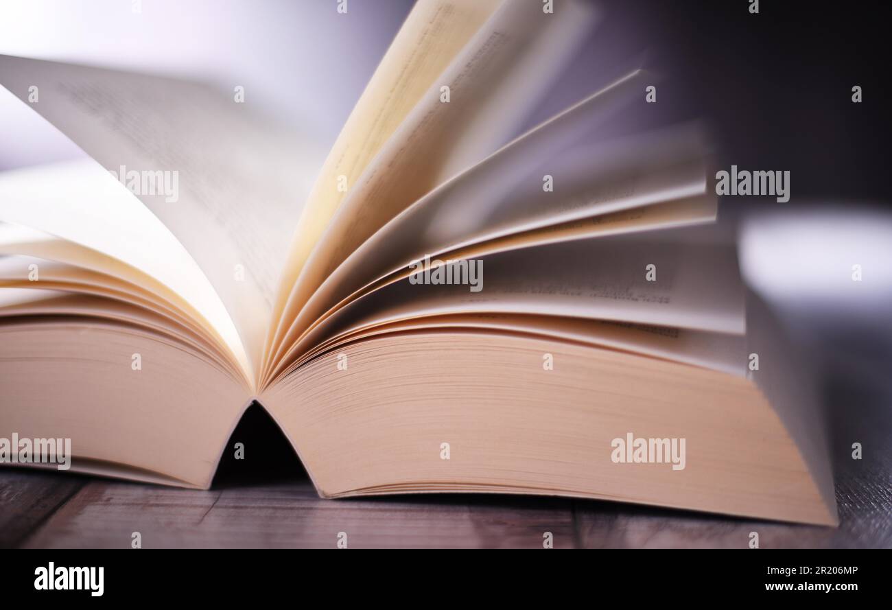 Composition with open book on the table Stock Photo - Alamy