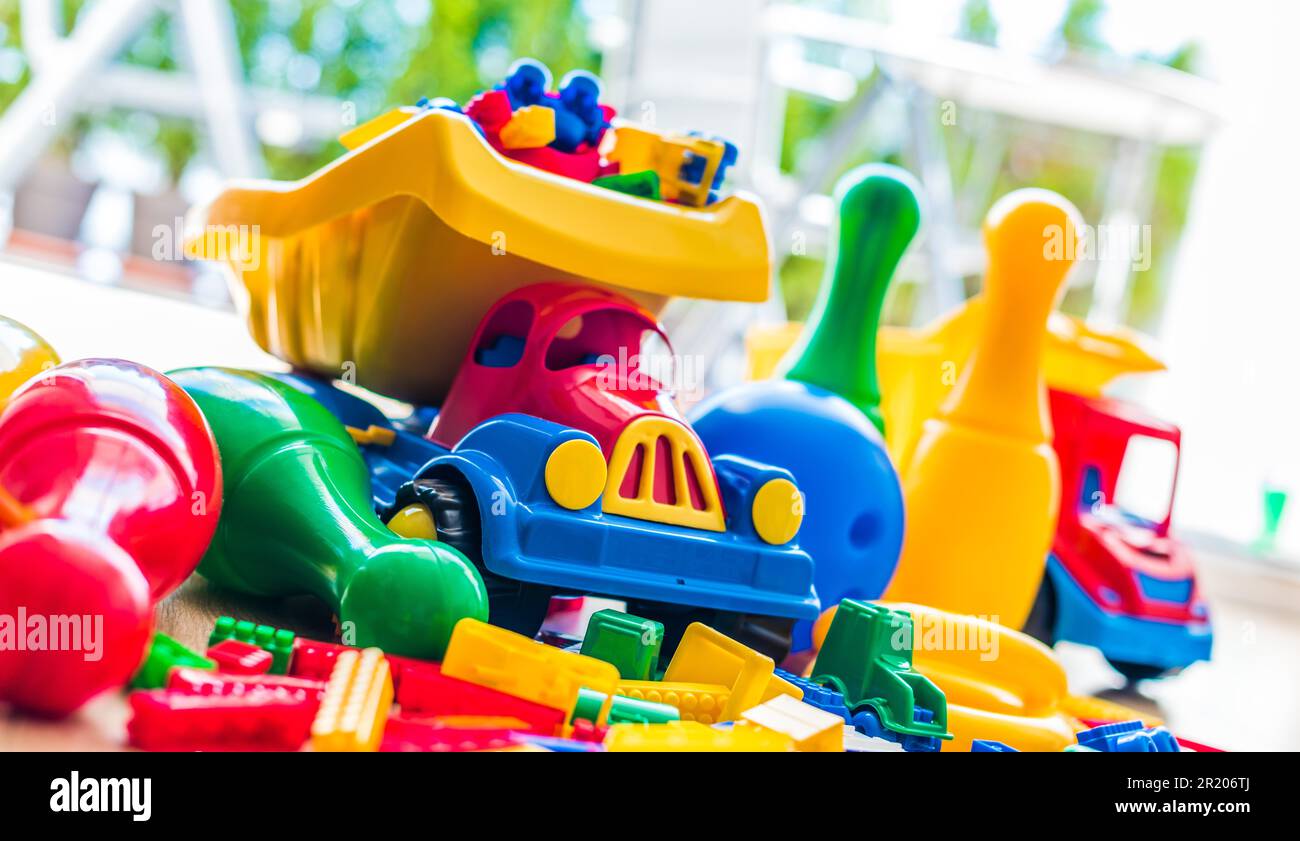 Colorful plastic children toys on the floor Stock Photo - Alamy