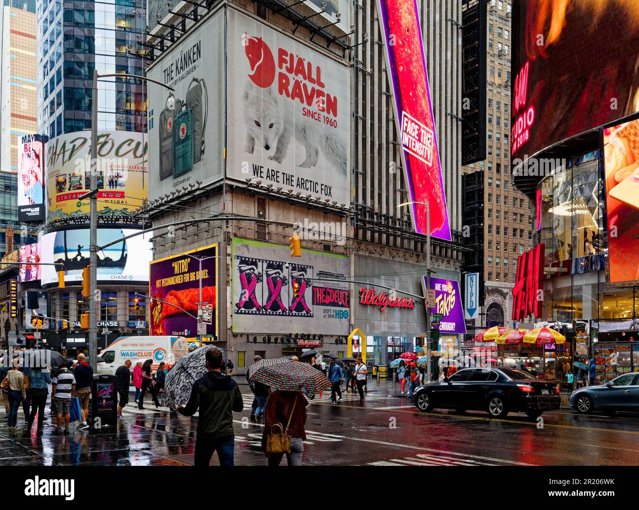 The umbrellas are out under a light September rain in Times Square ...