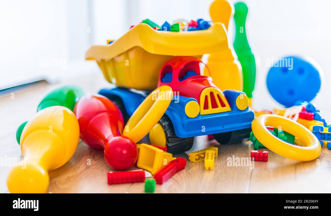 Colorful plastic children toys on the floor Stock Photo - Alamy