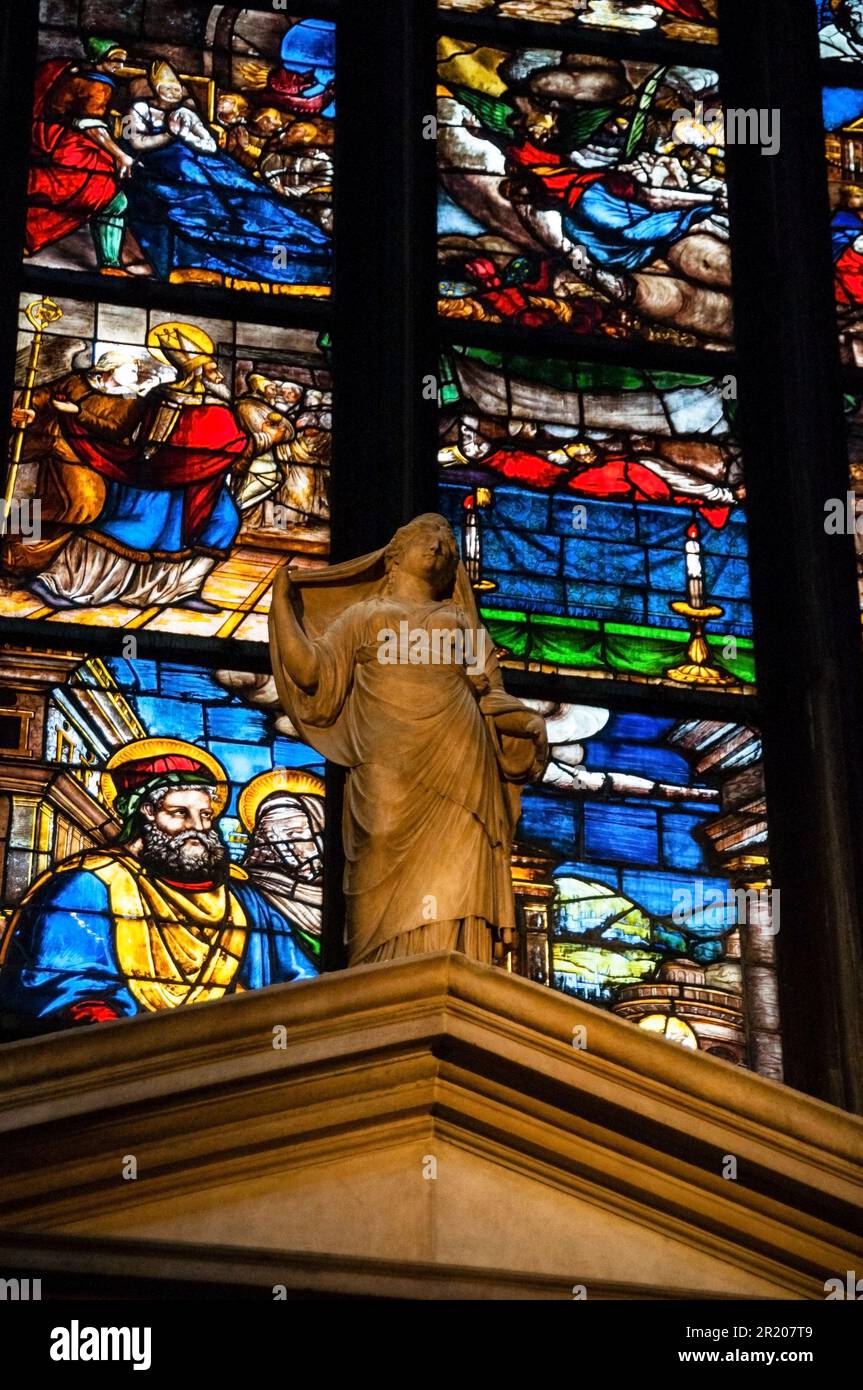 Sculpture standing on a triangle pediment and stained glass art in the ...