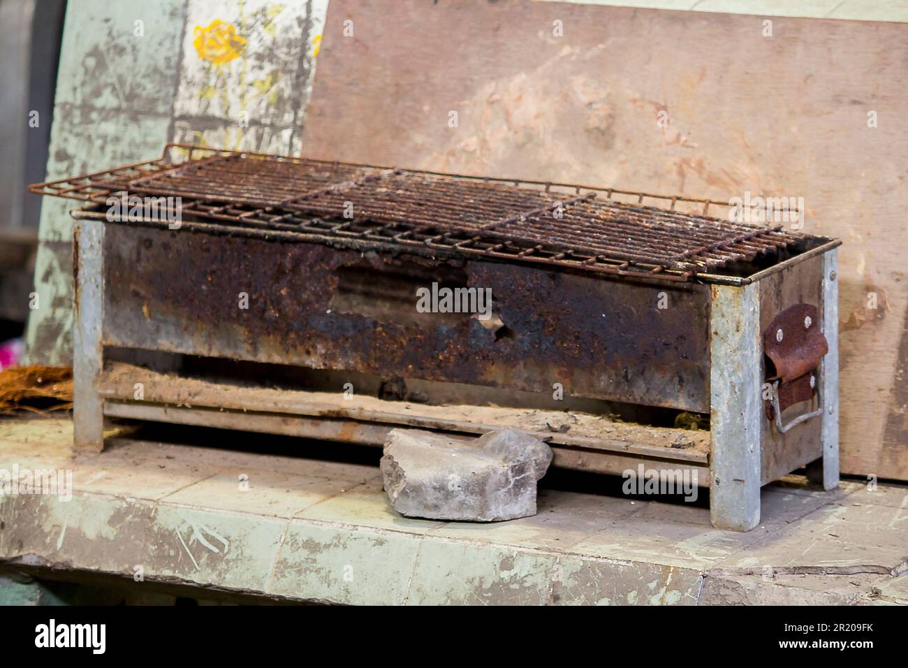 The old grill is rusty and placed on the floor Stock Photo - Alamy