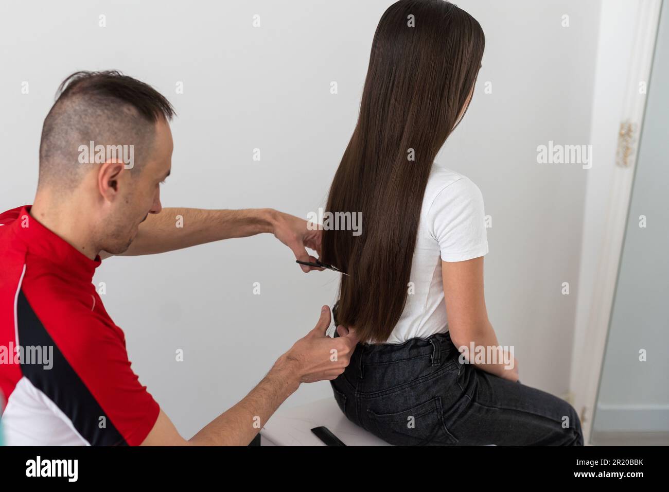 Father cutting hair of teenage daughter at home Stock Photo - Alamy