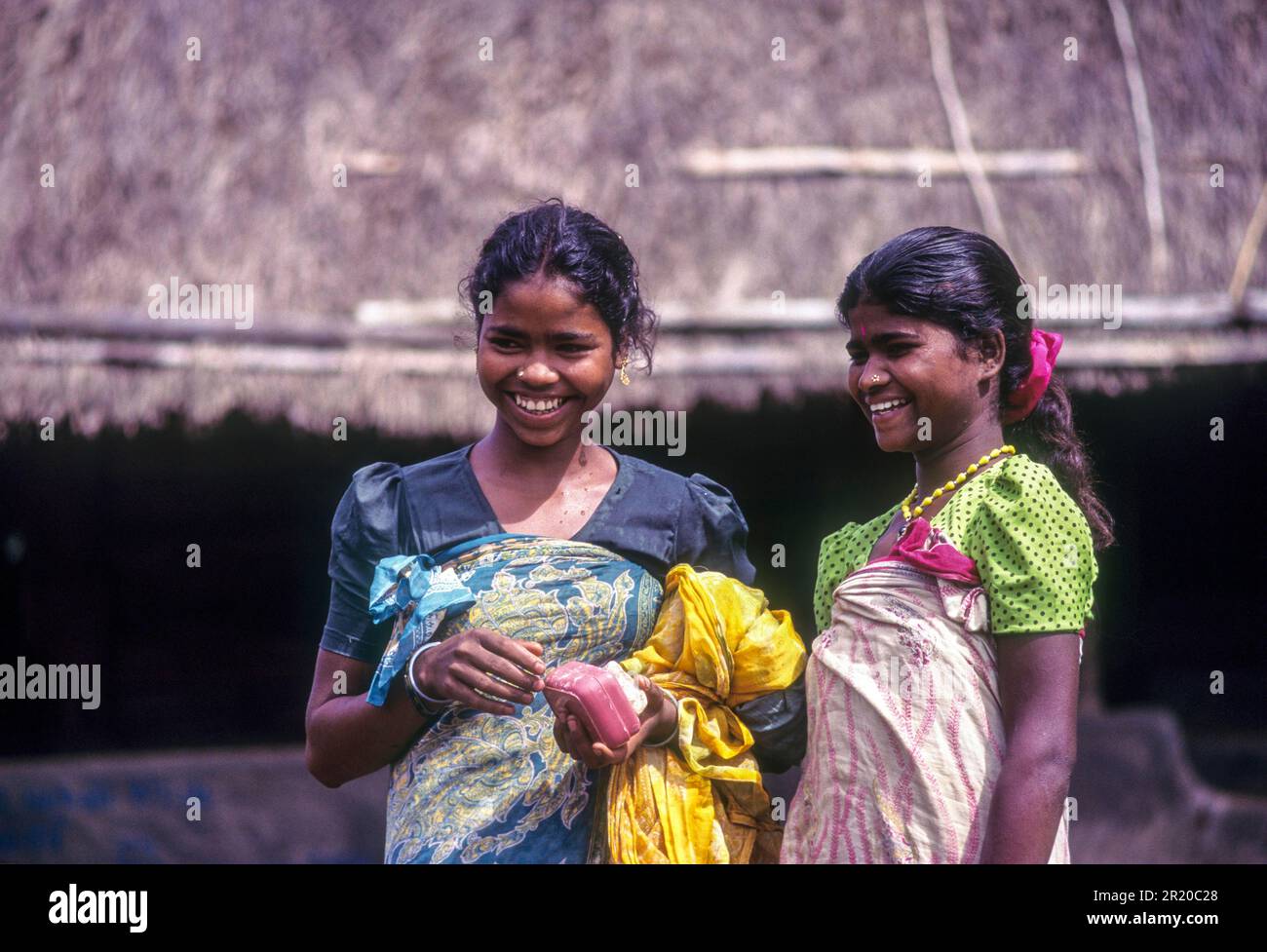 Betta kurumba tribal girls standing the tribal settlement at Theppakadu ...