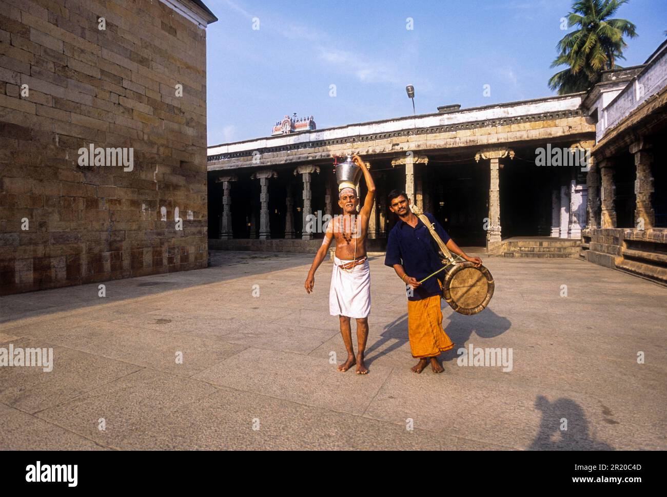 The priest carrying the holy water of river Kollidam on his head and ...