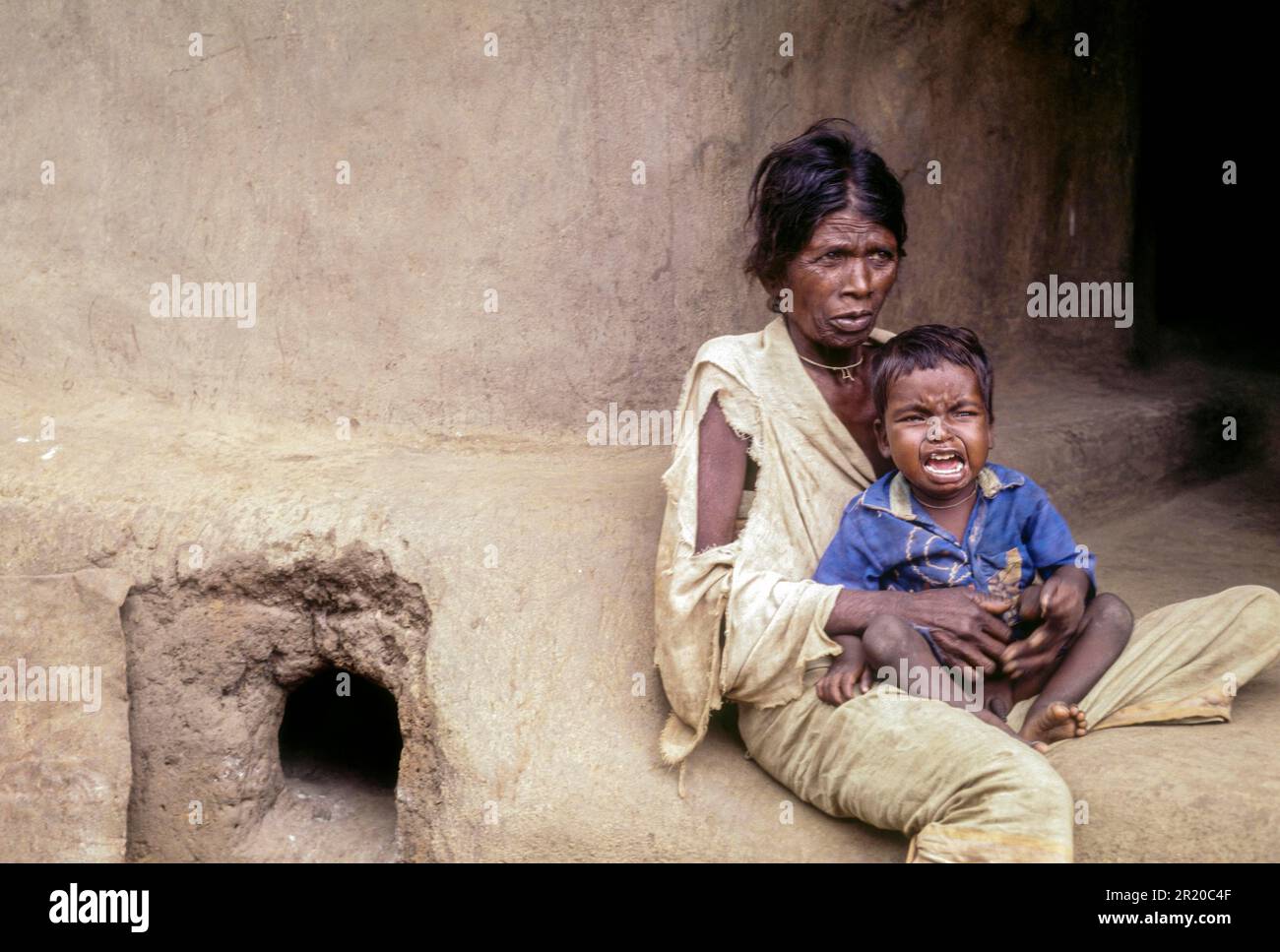 Jenu Kurumba tribal woman with her crying son, Nagarahole, Karnataka ...