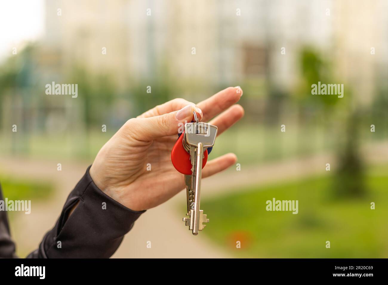 Hand holding keys, realtor, building Stock Photo - Alamy