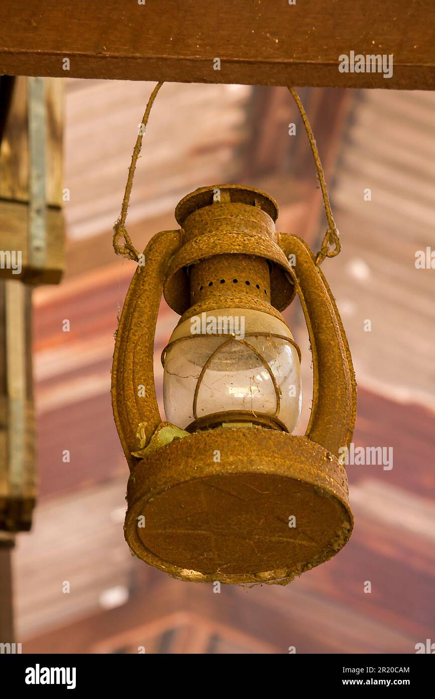 Old lantern hanging on a wooden beam Stock Photo - Alamy